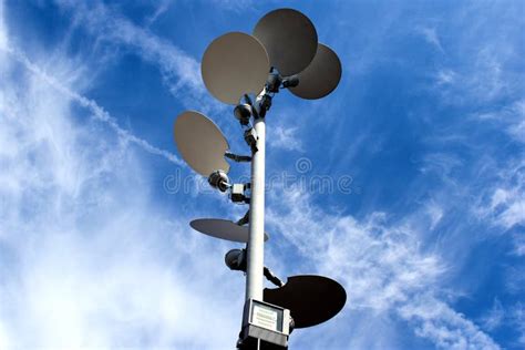 White Dish Shaped Light Deflectors And Reflectors On Vertical Pole