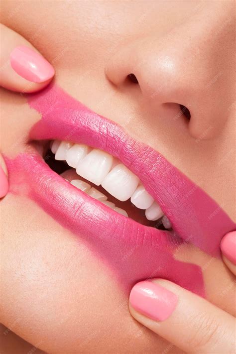 Premium Photo Spreading Pink Lipstick On Face In Close Up Photo