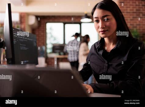 Asian Freelance Coder Analyzing Compiling Html Code On Computer Display