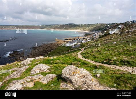 Hikers Walk Along The South West Coast Path Hiking Trail At Sennen Cove