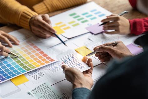 Group Of Ux Developer And Ui Designer Brainstorming About App Interface