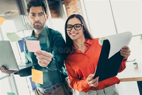 Two Professional Colleagues Discussing Plans In A Modern Workspace Collaboration And
