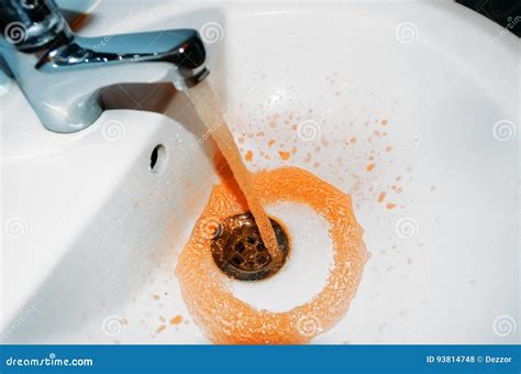 Rust Flowing From The Tap In The Bathroom Concept Of The Problem Is Dirty Water Stock Photo