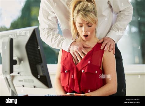Girl In Office Being Groped By Male Colleague Stock Photo Alamy