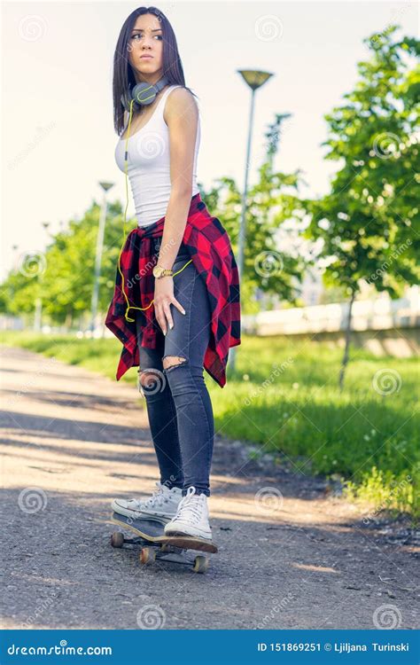 Girl Skateboarder Sporty Legs Skateboarding In Park Stock Image