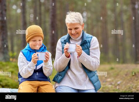 Grandmother With Grandson Drinking Tea In Forest Stock Photo Alamy