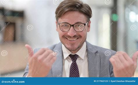 Portrait Of Assertive Businessman Inviting Customers Stock Image
