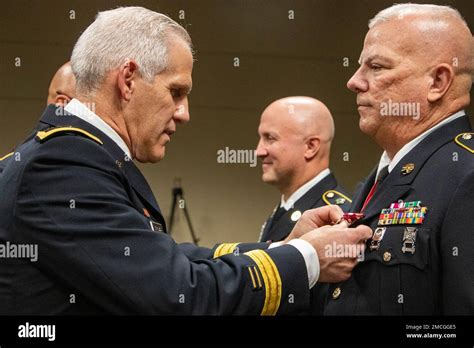 Brig. Gen. Rodney Fischer, commanding general, 104th Training Division, pins the Meritorious ...