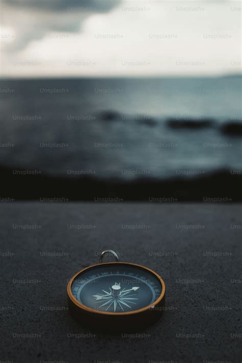 Compass Travel In Front Of Water Ocean Landscape Concept Of Lost And