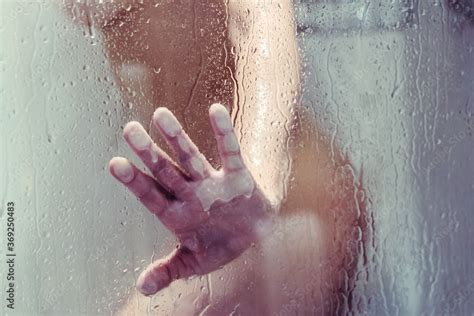 Naked Beautiful Woman Taking A Shower And Touches Hand Wet Misted Glass Stock Photo Adobe Stock