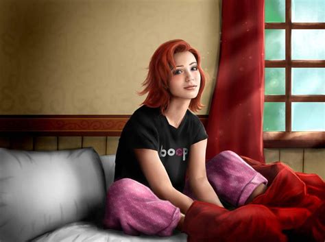 A Woman Sitting On Top Of A White Couch Next To A Red Curtain And Window