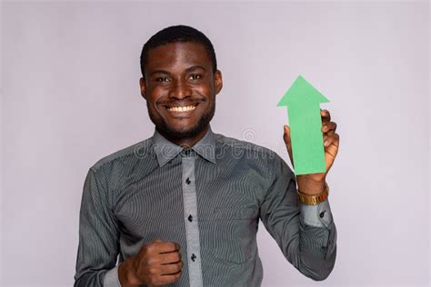 African Man Holding An Arrow Pointing Upwards Stock Photo Image Of Improvement Pointing