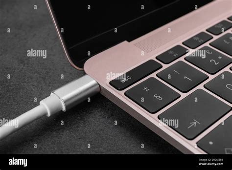 Usb Cable Plugged Into Laptop Port On Dark Table Closeup Stock Photo Alamy