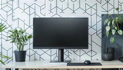 A Minimalist Computer Desk Setup With A Sleek Black Monitor Geometric