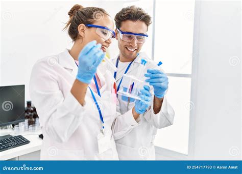 Man And Woman Wearing Scientist Uniform Holding Test Tube At Laboratory Stock Image Image Of