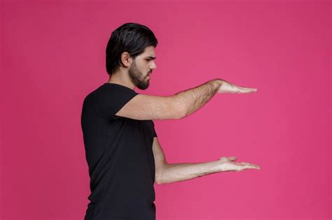 Free Photo Man Showing The Estimated Height Of An Object