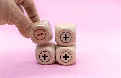 Premium Photo Plus And Minus Icons On Wooden Cubes Separate The Negative From Positive
