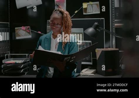 Law Office Analyzing Case Files With Evidence To Solve Crimes And Catch Suspects Working On