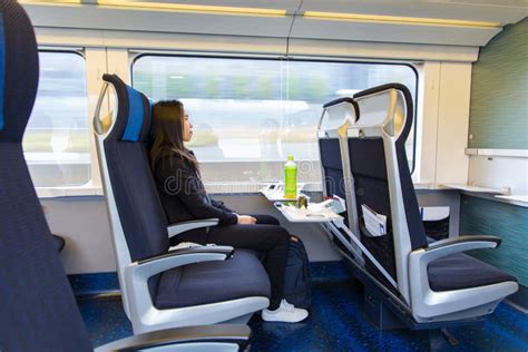 Cute Young Asian Female Tourists Sitting On The Express Train Stock