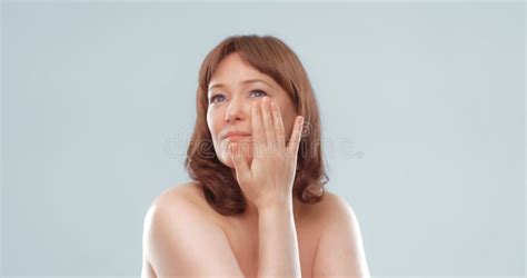 Mature Naked Woman Touches Cheek With Hand Looking Up Isolated On White Background With Empty