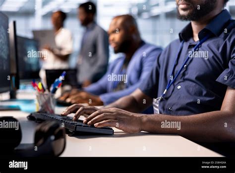 Team Of Developers In Data Center Using Diagnostic Tools And System Monitoring Software To