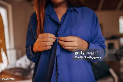 Woman Putting On Shirt In Bedroom Photos And Premium High Res Pictures