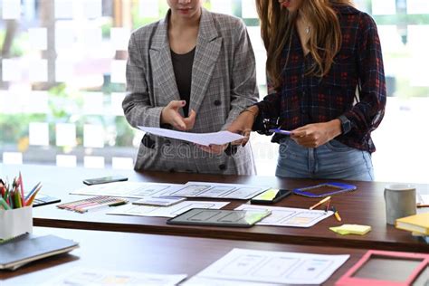 Two Female Designer Brainstorming And Discussing For Mobile Application