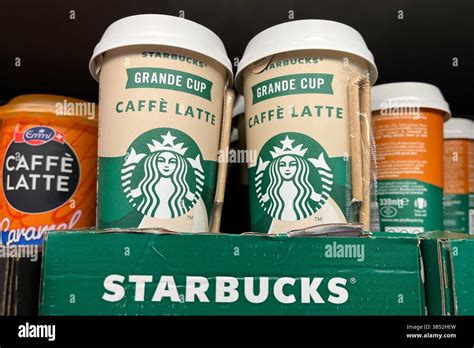 Two Starbucks Grande Cup Caffe Latte Drinks For Sale On A Supermarket