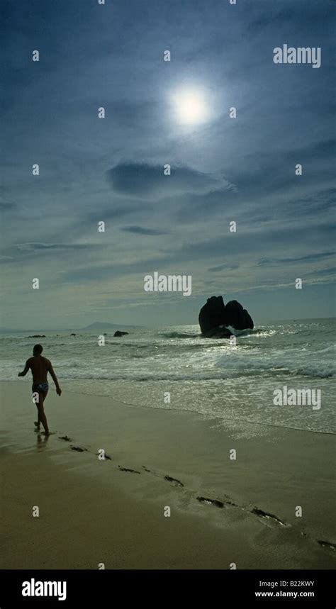 Man On Beach With Footprints Stock Photo Alamy