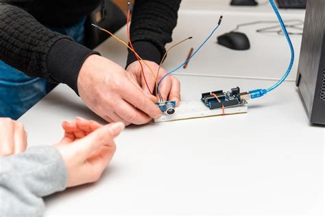 Premium Photo Teacher Helping His Teen Student With Diy Robot On Stem Education ClassStudent