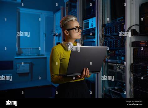 Portrait Of Concentrated Woman Coder Solving Problem In Data Center