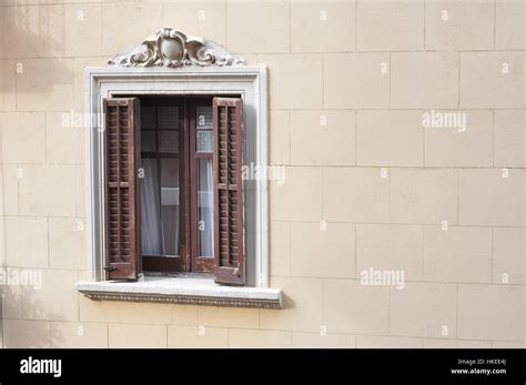 Classical Window With Timbre Shutters On Yellow Wall In Spain Stock