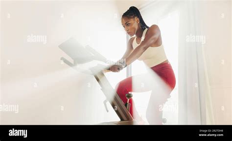 Focused Young Woman Tackling Her Fitness Training Head On Using A