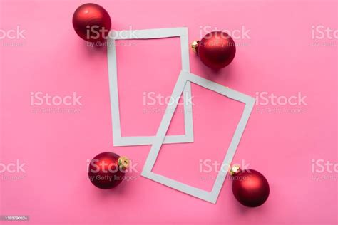 메리 크리스마스와 새해 복 야 흰색 모형 사진 프레임과 분홍색 배경에 빨간 공 플랫 누워 사진 최소한의 개념 Xmas 인사말 카드 배너 텍스트의 공백 복사 0명에 대한 스톡
