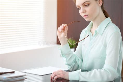 Business Woman Or Secretary Sitting At The Desk In The Office Green