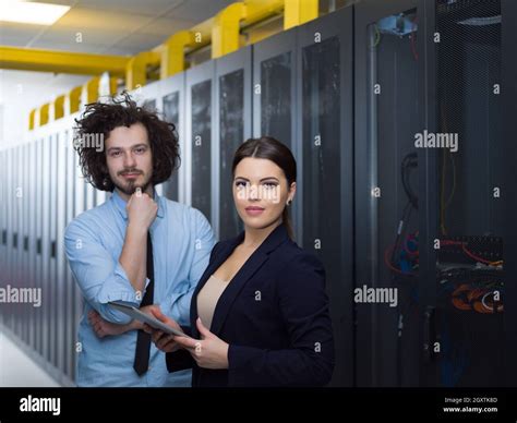 Young It Engineer Showing Working Data Center Server Room To Female