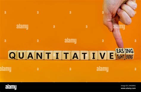 Quantitative Easing Or Tightening Symbol Businessman Turns Cubes