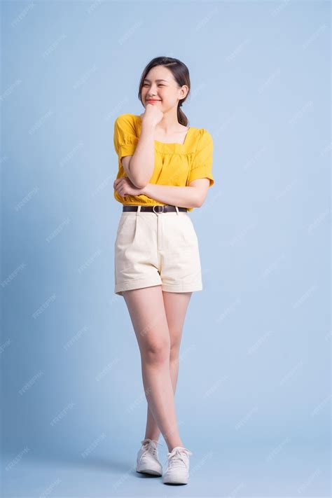 Premium Photo Full Length Image Of Young Asian Woman Posing On Blue