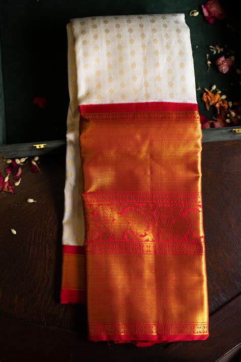 White Kanchipuram Silk Saree With Red Long Border
