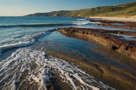 A Coastal Inlet With Sand And Rocky Patches Premium Ai Generated Image