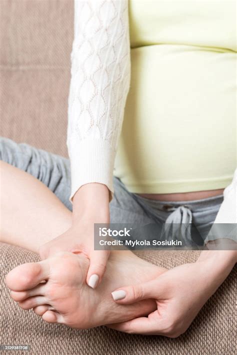 Leg Cramps During Pregnancy Closeup Of Hands Massaging Swollen Foot