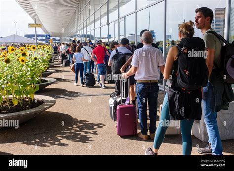 Very Long Queues Of Passengers Waiting To Get Through Security Outside Schiphol Airport