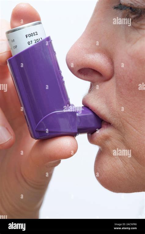 Adult Female Patient Uses A Seretide Inhaler To Treat Asthma Or Copd