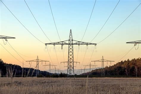 High Voltage Power Lines Over A Field At Sunset Stock Image Image Of