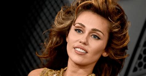 Miley Cyrus Flaunts Bare Legs In Gold Feathered Bodysuit Parade