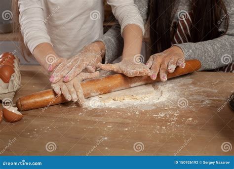 Mother And Her Daughter Are Baking A Bread And Having Fun At The