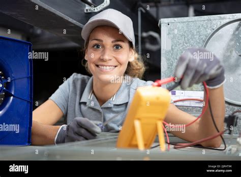 Female Electrician Testing Charge To Spotlight Stock Photo Alamy
