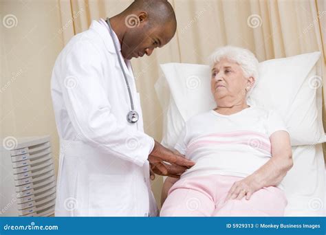 Doctor Giving Checkup To Woman In Exam Room Stock Image Image Of