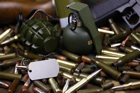Premium Photo Different Types Of Ammunition And Grenades On A Camouflage Background Preparing