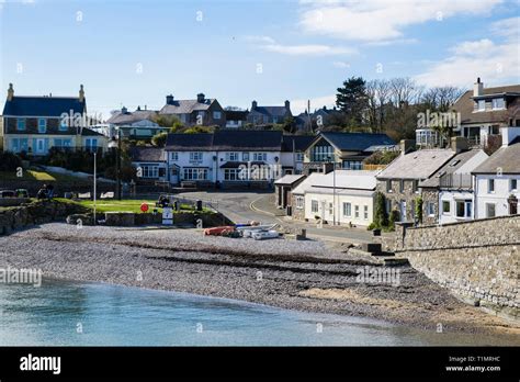 View Across Beach To Cottages And Pub On Waterfront In Village Of